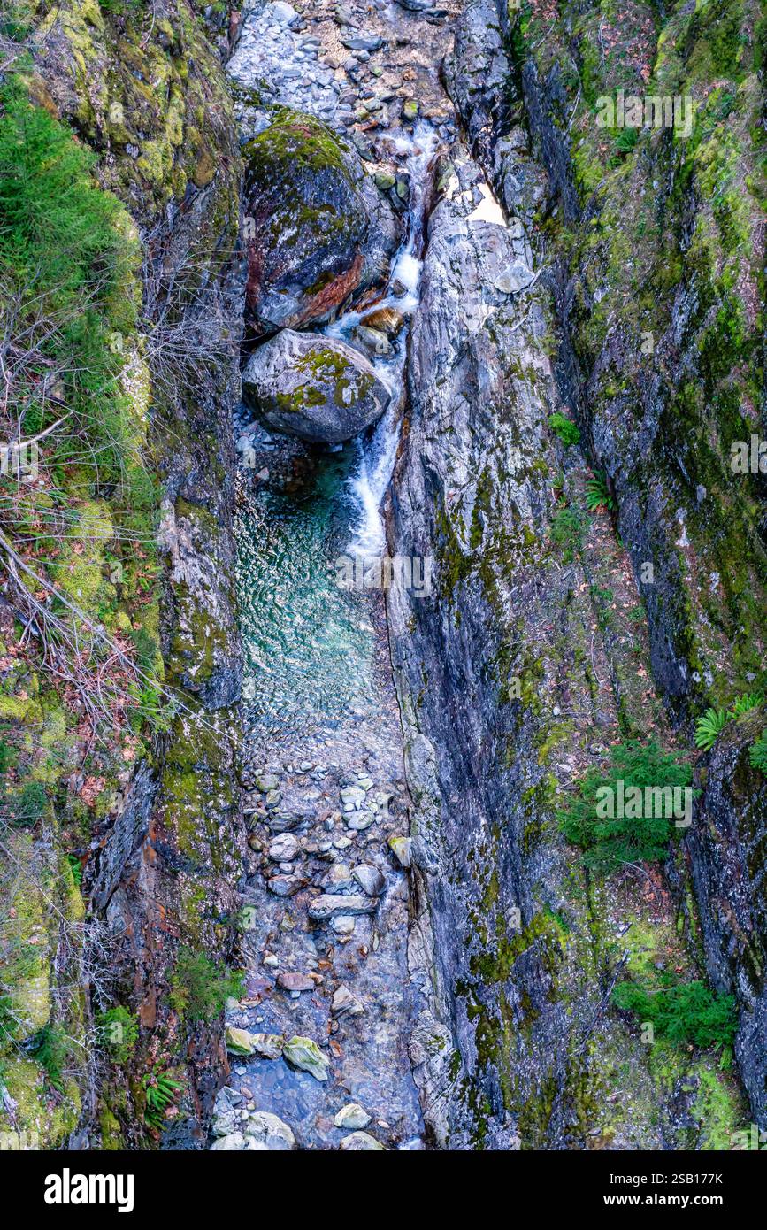 A view of a stream flowing down steep cliffs along Highway 20 in ...