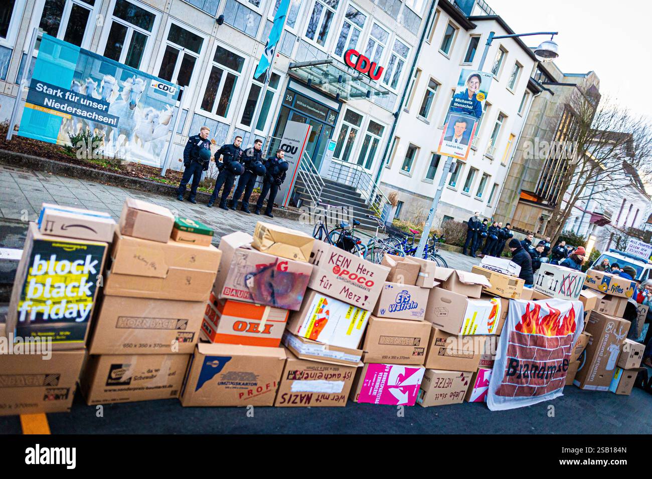 31 January 2025, Lower Saxony, Hanover: Cardboard boxes symbolize a ...