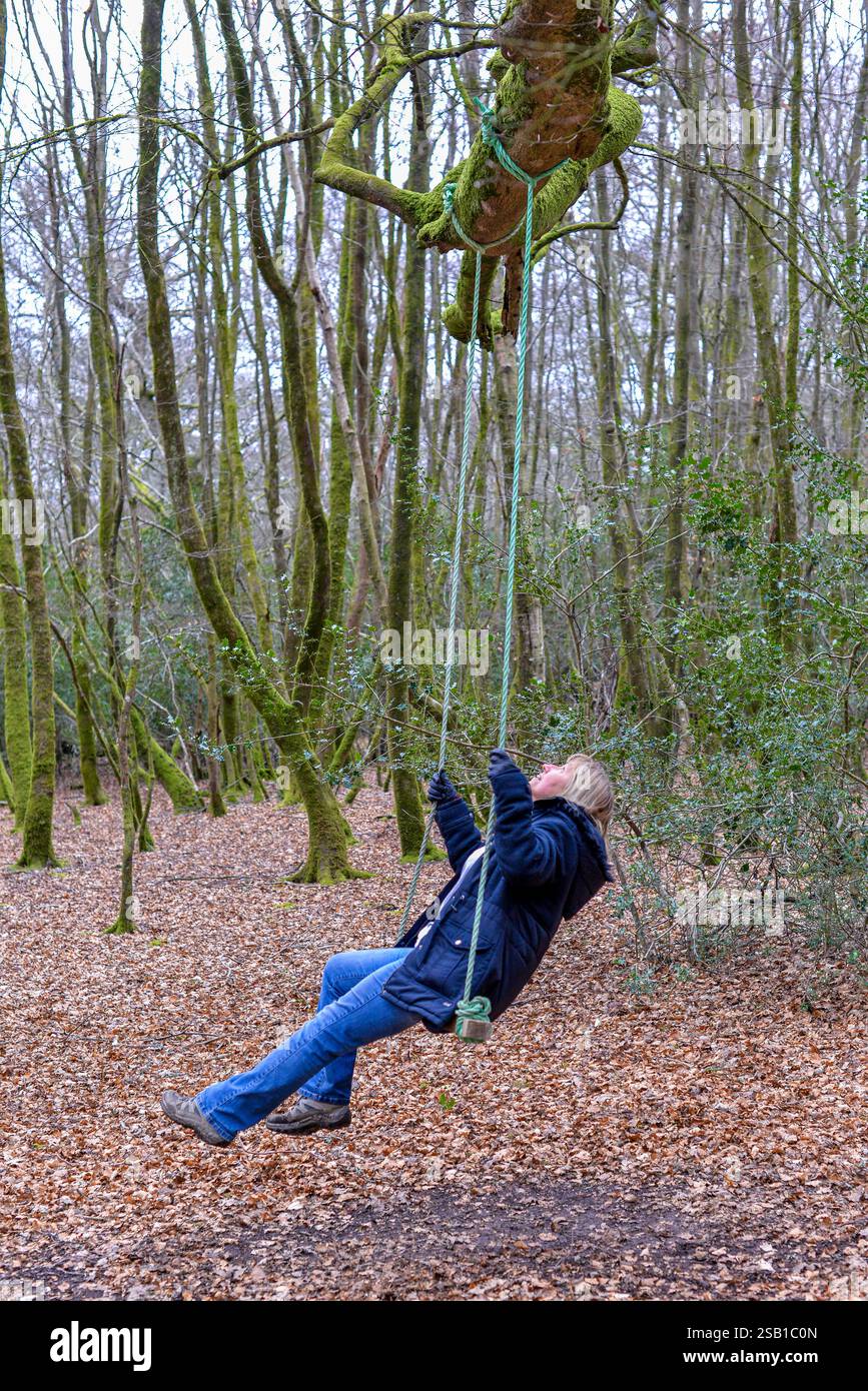 Woman on swing rope hi-res stock photography and images - Alamy
