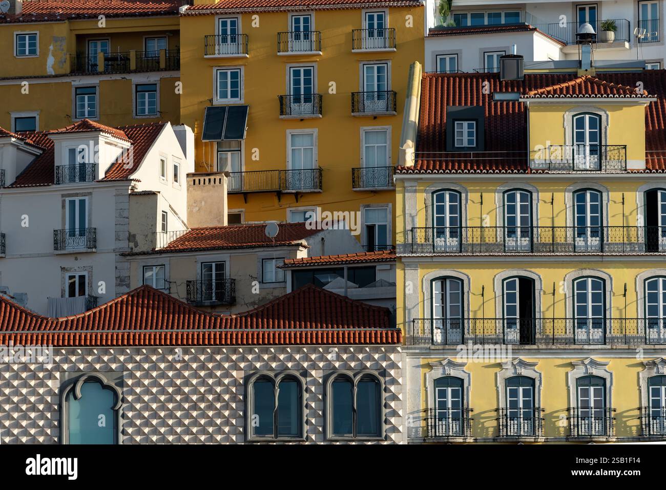 Overlapping building facades in the historic Alfama neighbourhood in ...