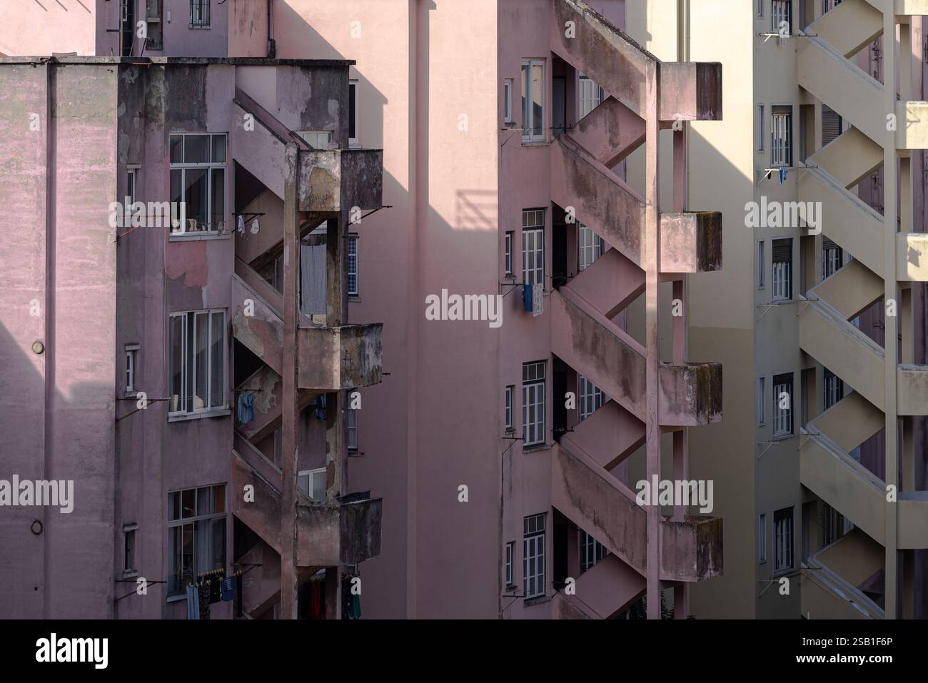 Faded pastel coloured apartment building facades with external ...