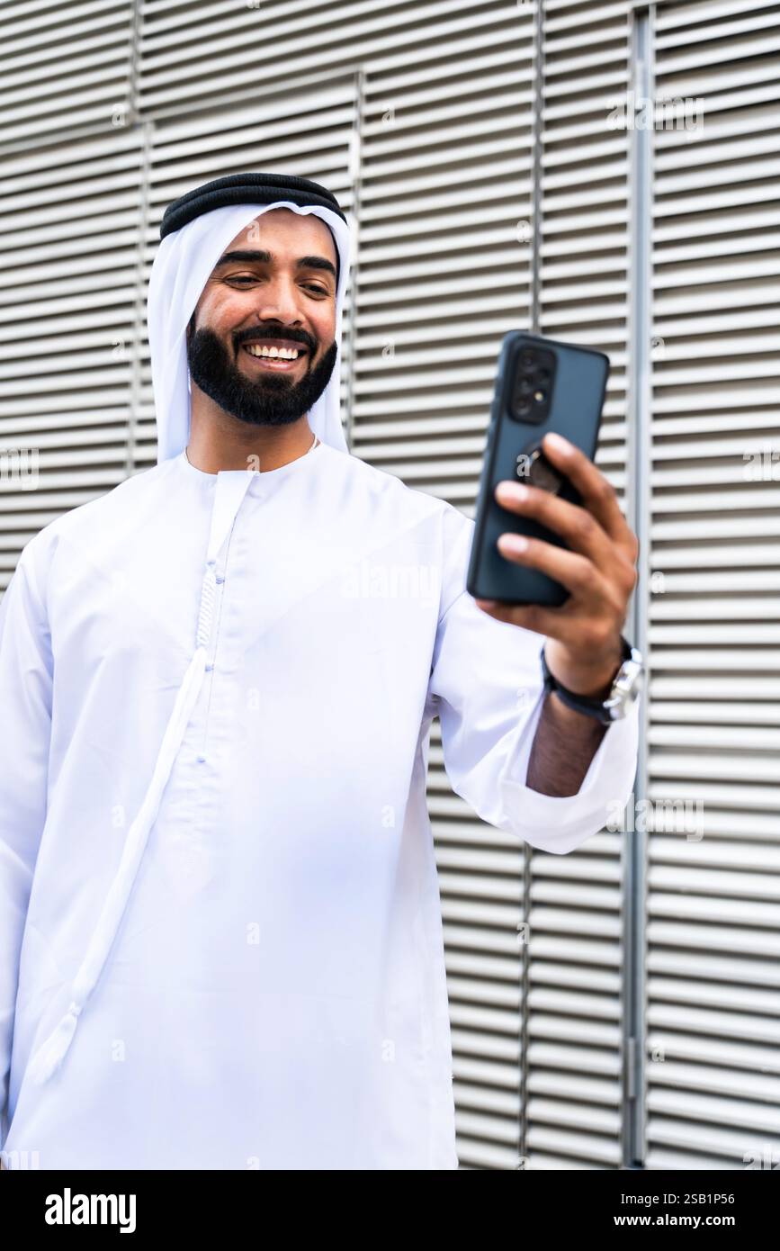 Portrait of handsome arab businessman wearing traditional emirati ...