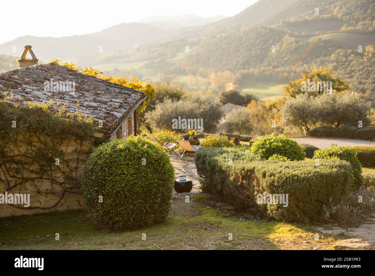A serene Tuscan landscape featuring rustic houses, lush greenery, and ...