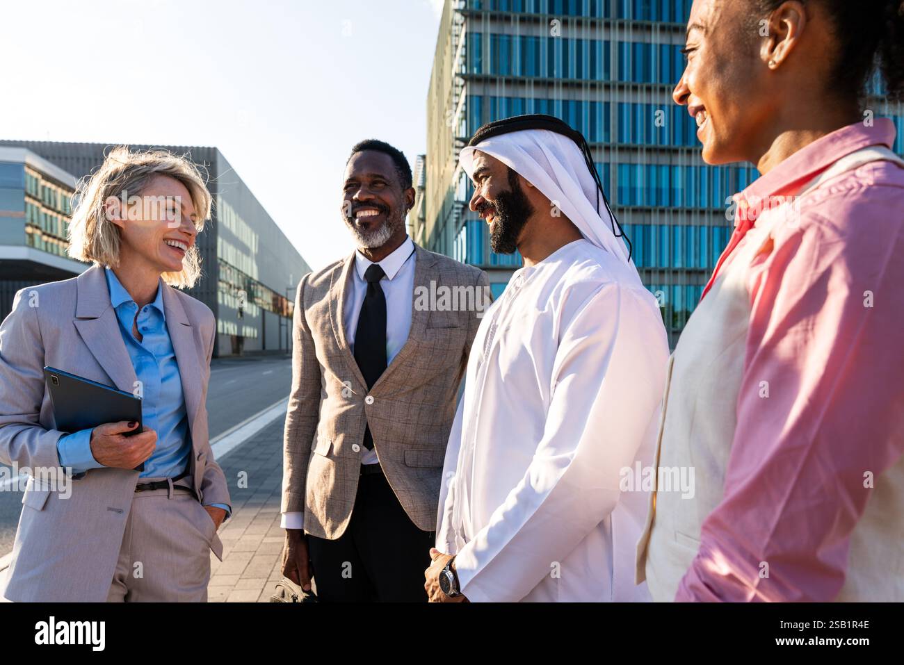 Group of multiethnic business people meeting an emirati businessman ...