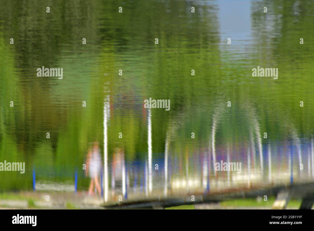 Reflections of the pedestrian bridge on the surface of the waters of ...