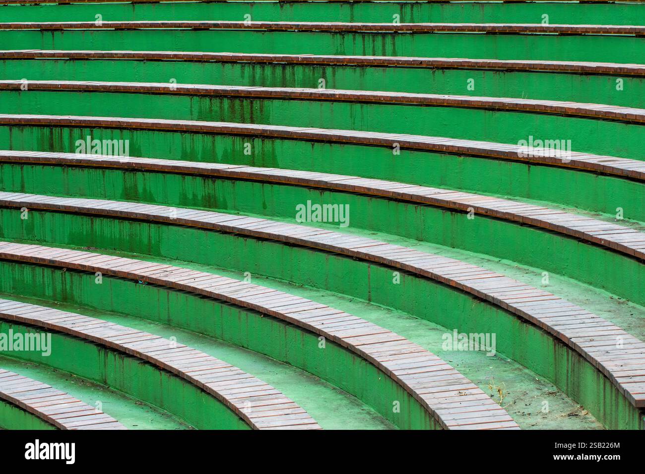 Curved Harmony: Green Concrete & Wooden Seating in the Park Stock Photo ...