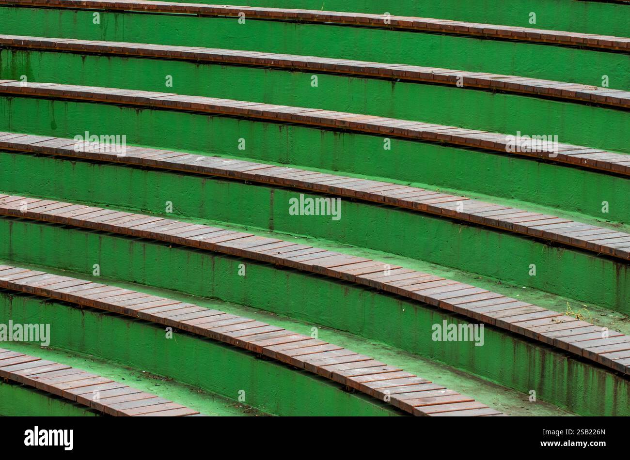 Curved Harmony: Green Concrete & Wooden Seating in the Park Stock Photo ...