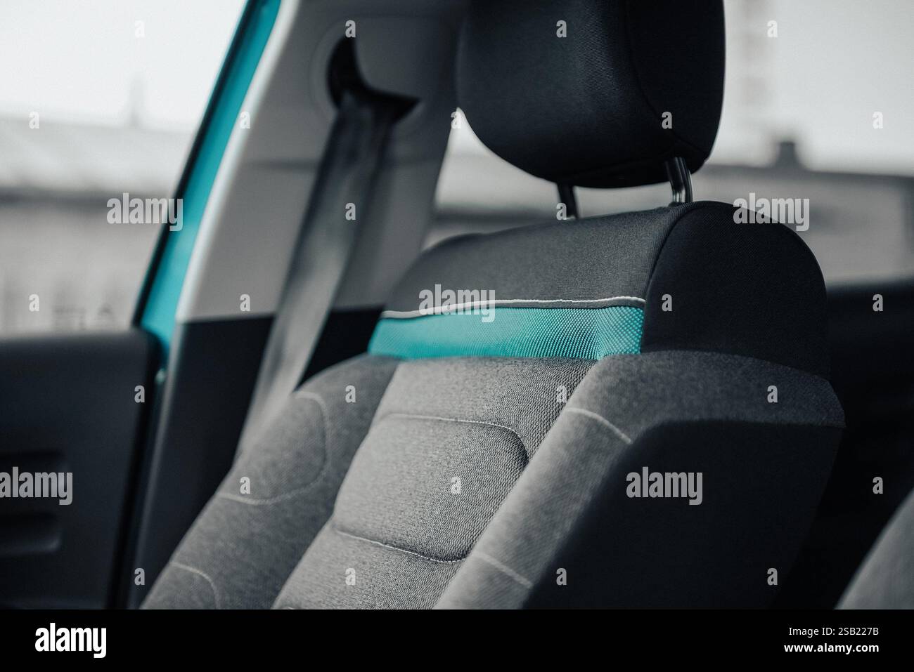 Car interior seat with turquoise trim - close-up image. Front cloth ...