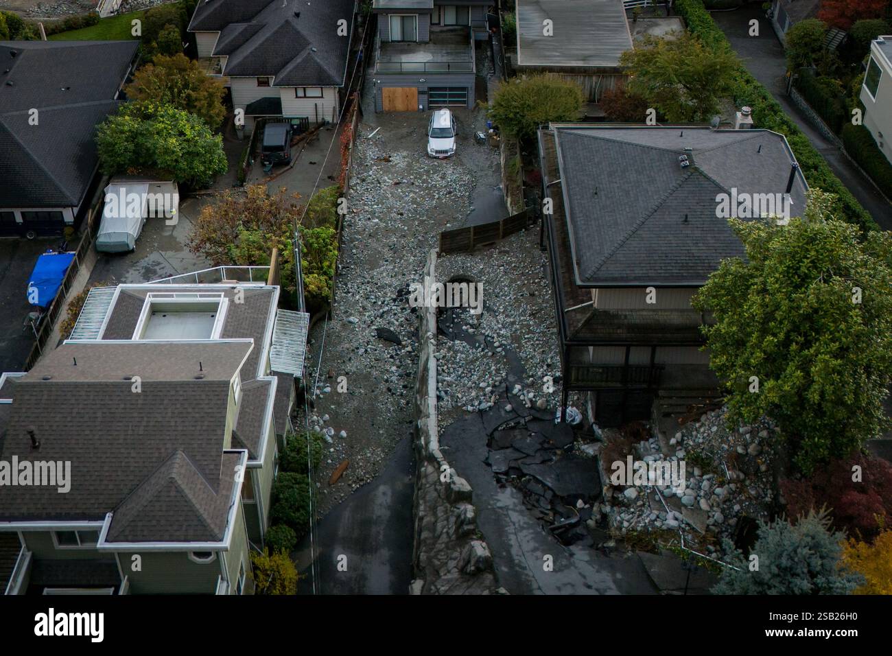 Multiple homes are seen surrounded by debris left by flooding from ...