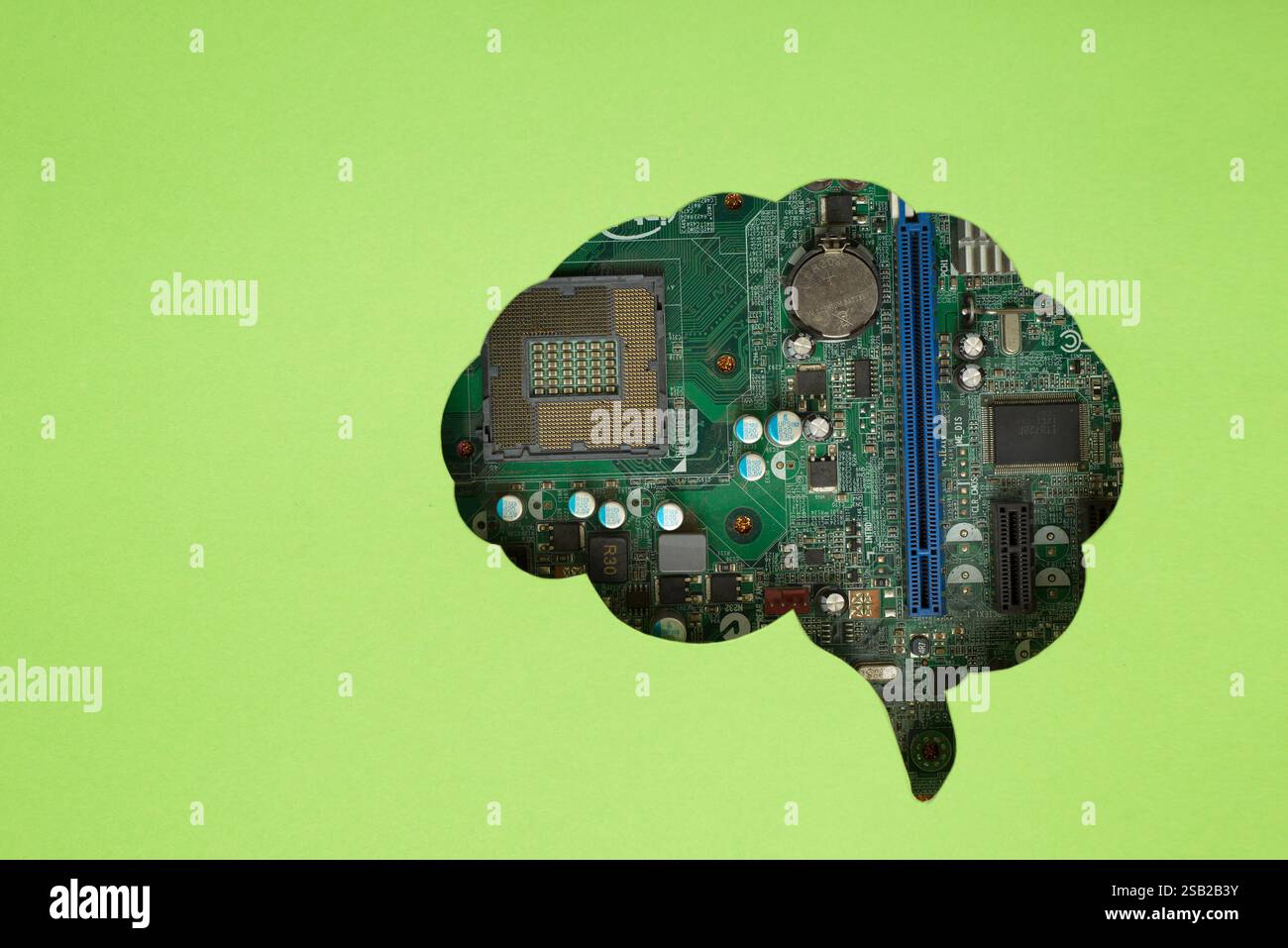 Green sheet of paper with brain-shaped hole revealing a computer ...