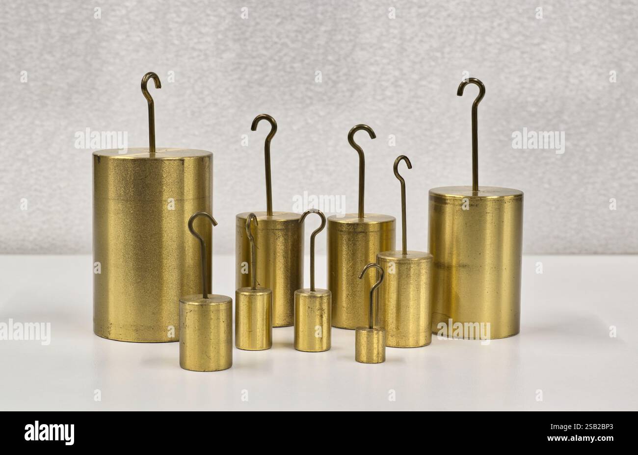 Brass hooked weights scientific laboratory measuring equipment on table ...