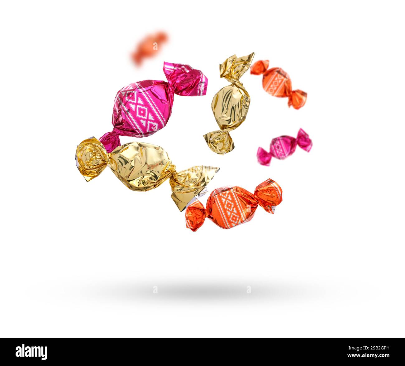 Candies in bright wrappers falling on white background Stock Photo - Alamy