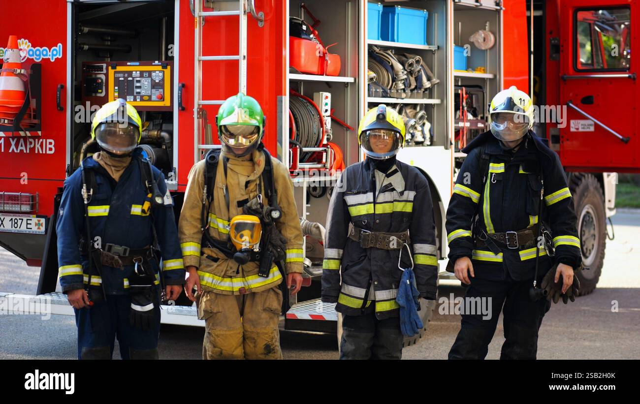 Portrait of male and female firefighters in helmets and protective ...