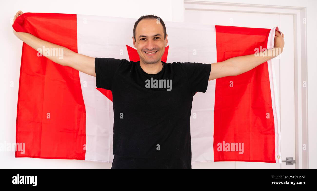 young man with a canada national flag on the soulders, patriotism and ...