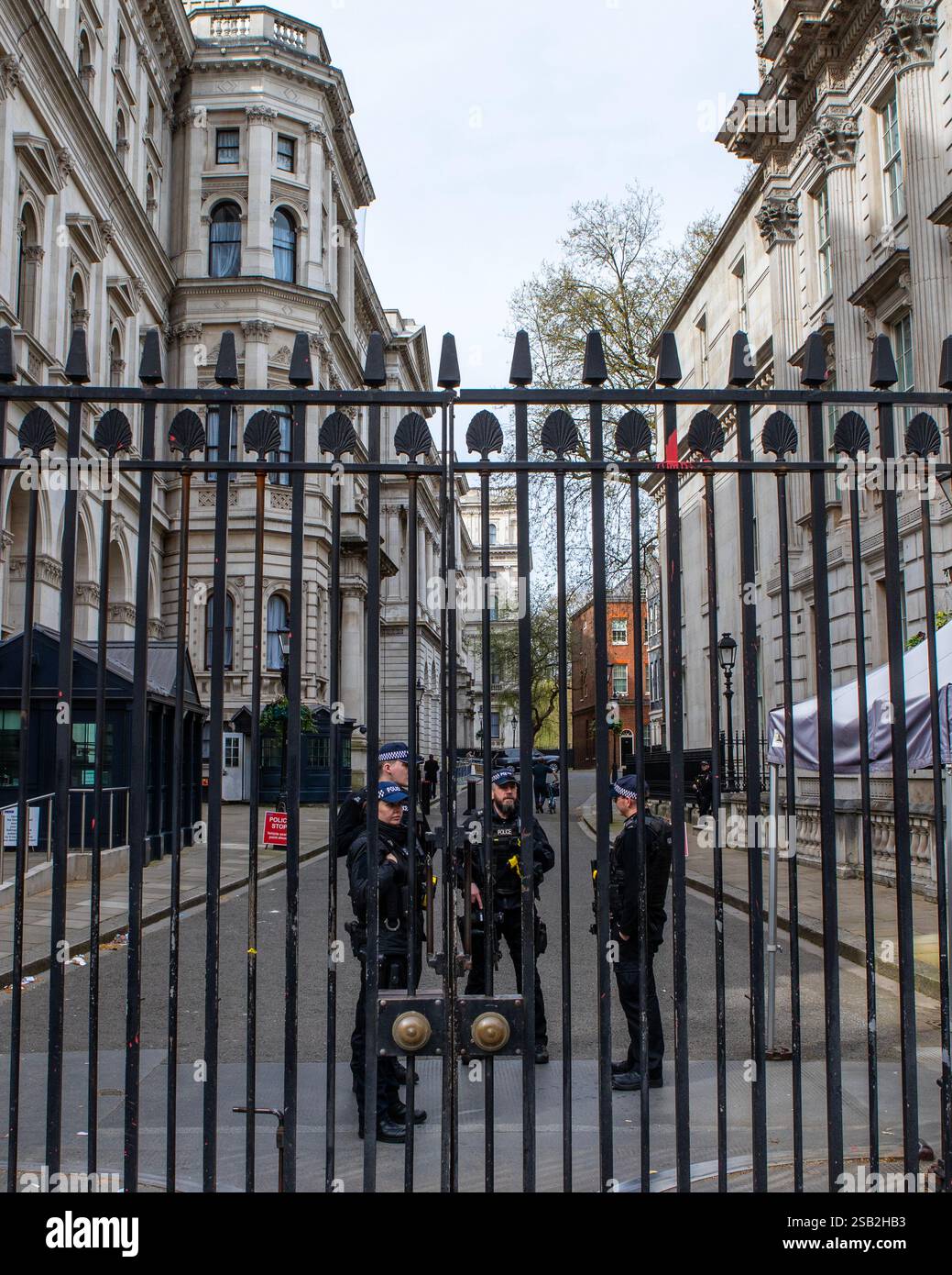 London, UK - April 8th 2024: Gates and armed police at the entrance to ...