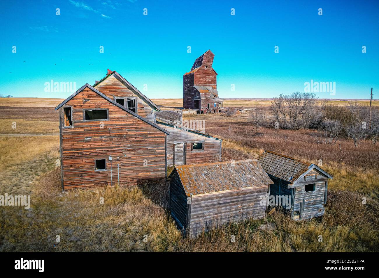 A house with a barn in the background. The barn is old and has a lot of ...