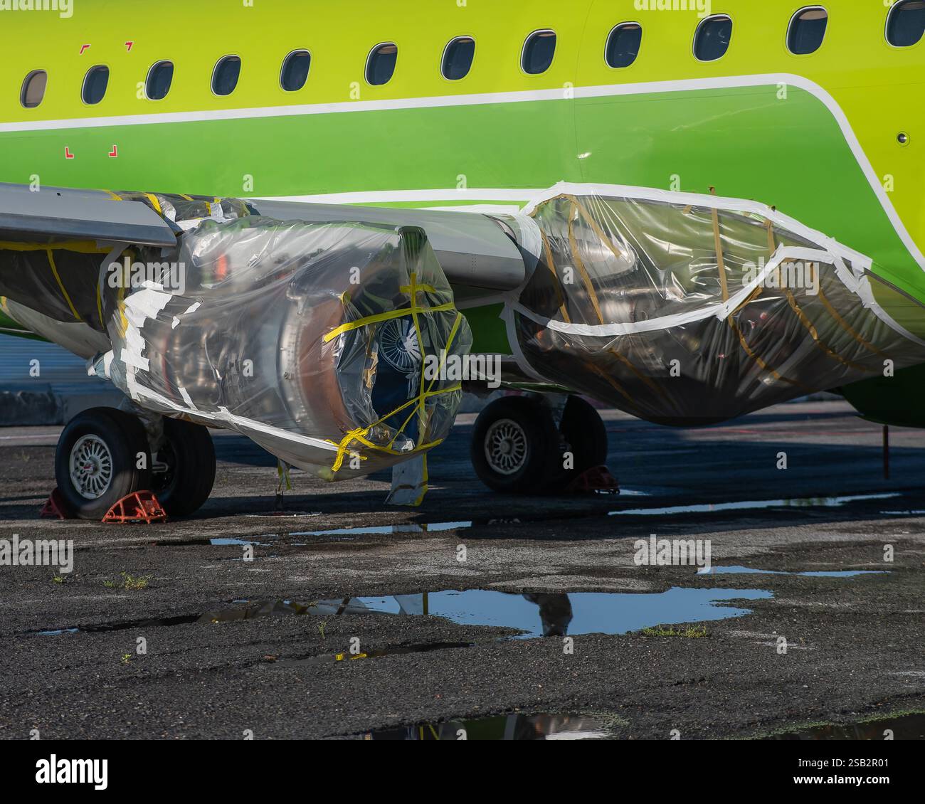 An airplane turbine undergoing repairs is wrapped in film Stock Photo ...