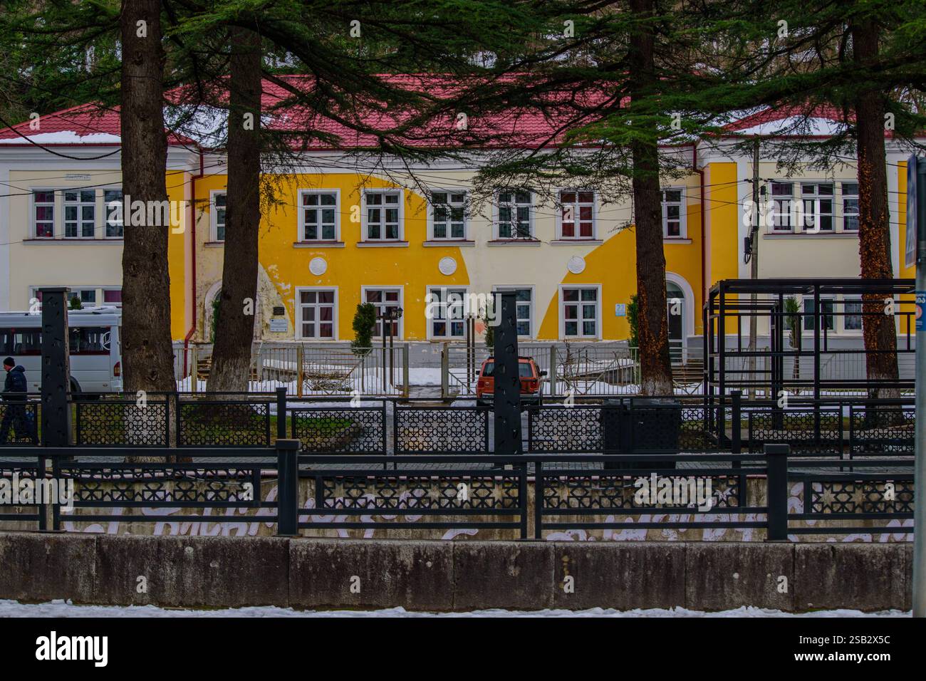 A long building with windows and a detailed brick structure under a sky ...
