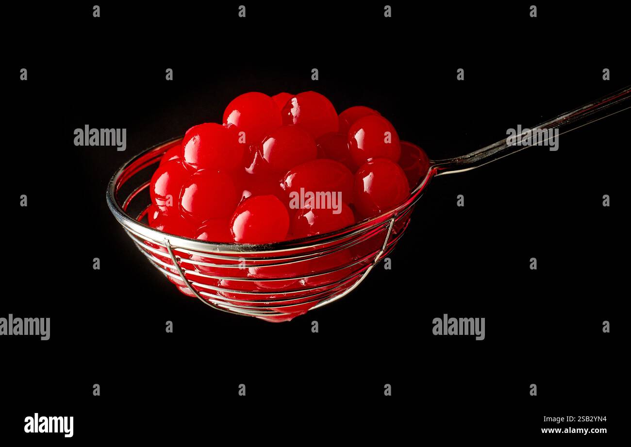 red jelly balls for making bubble tea in a strainer on grey background ...