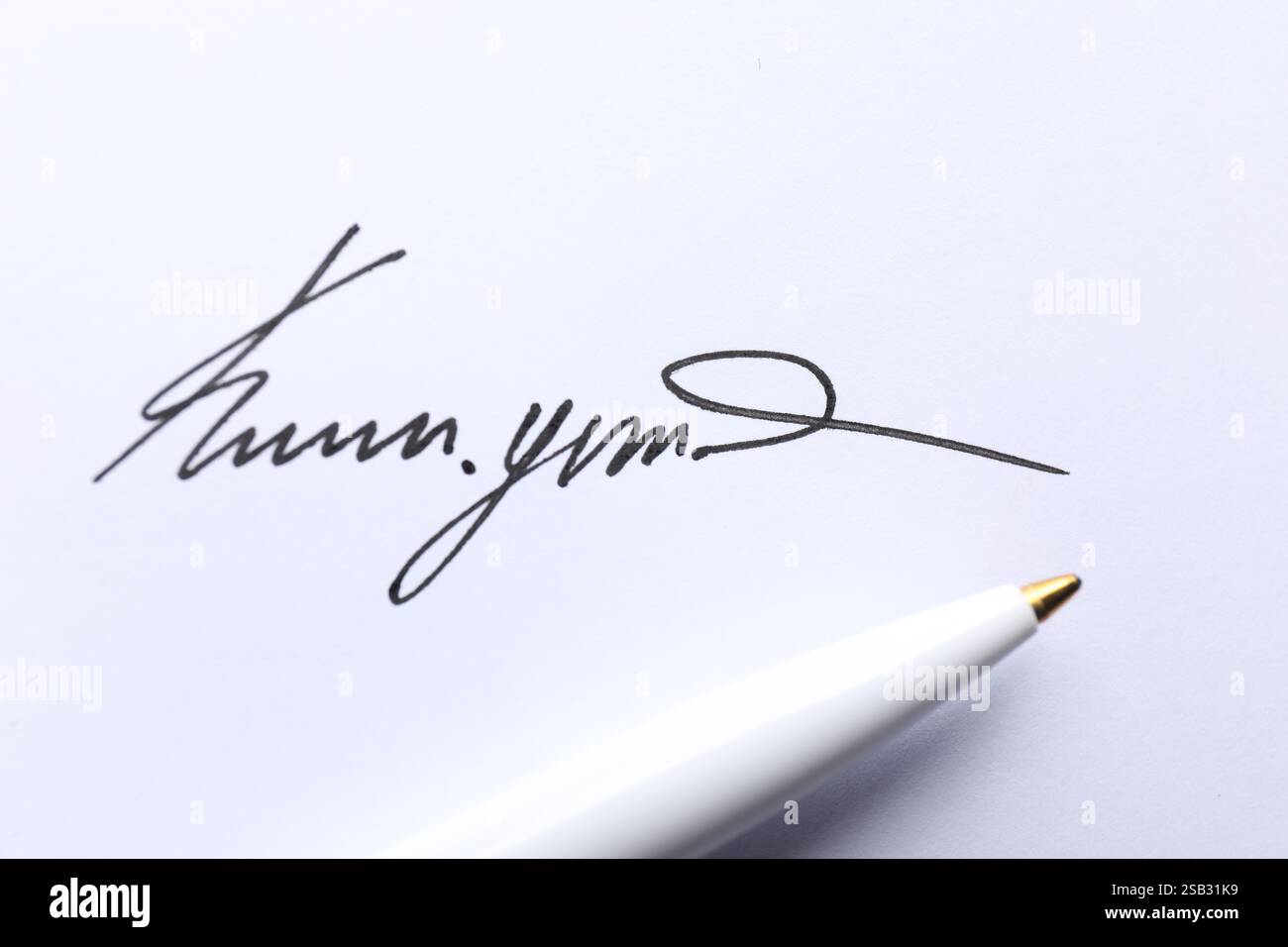 Pen and signature on white paper, closeup Stock Photo - Alamy