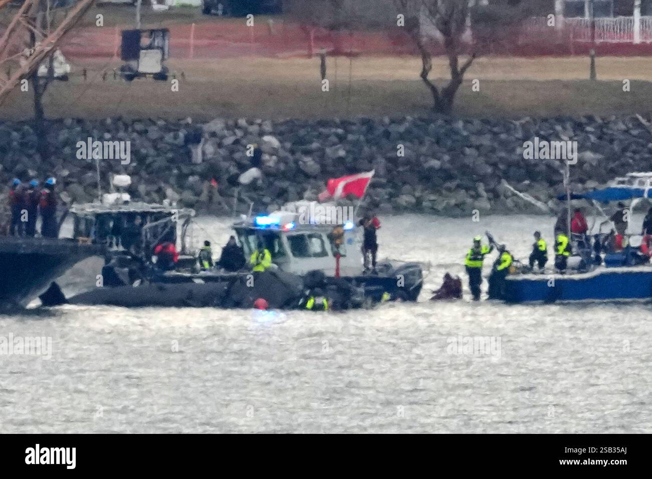 A Coast Guard vessel with a crane is pictured as it works near the ...