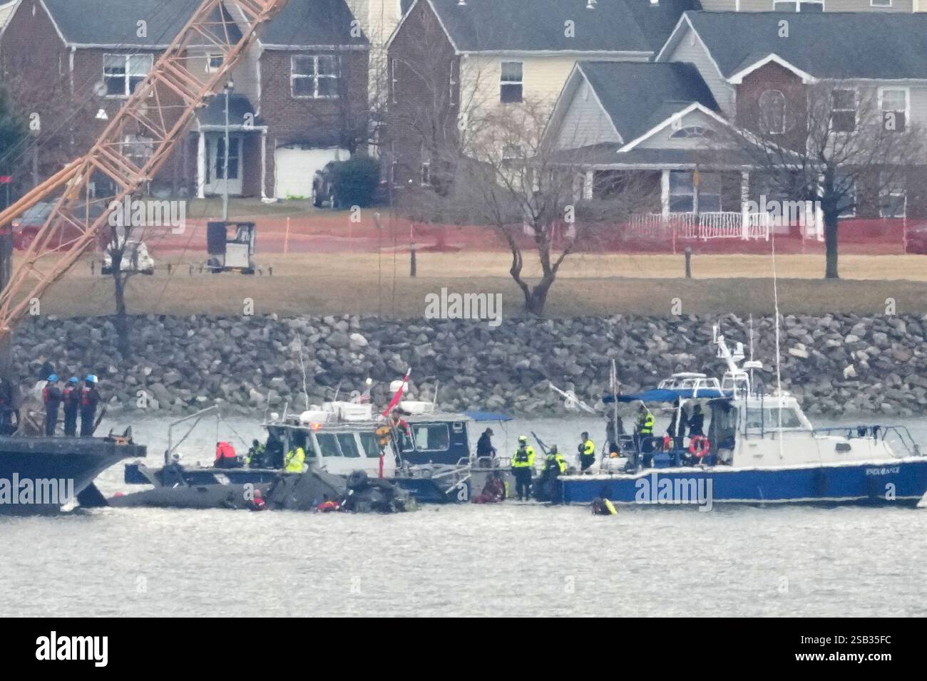 A Coast Guard vessel with a crane is pictured as it works near the ...