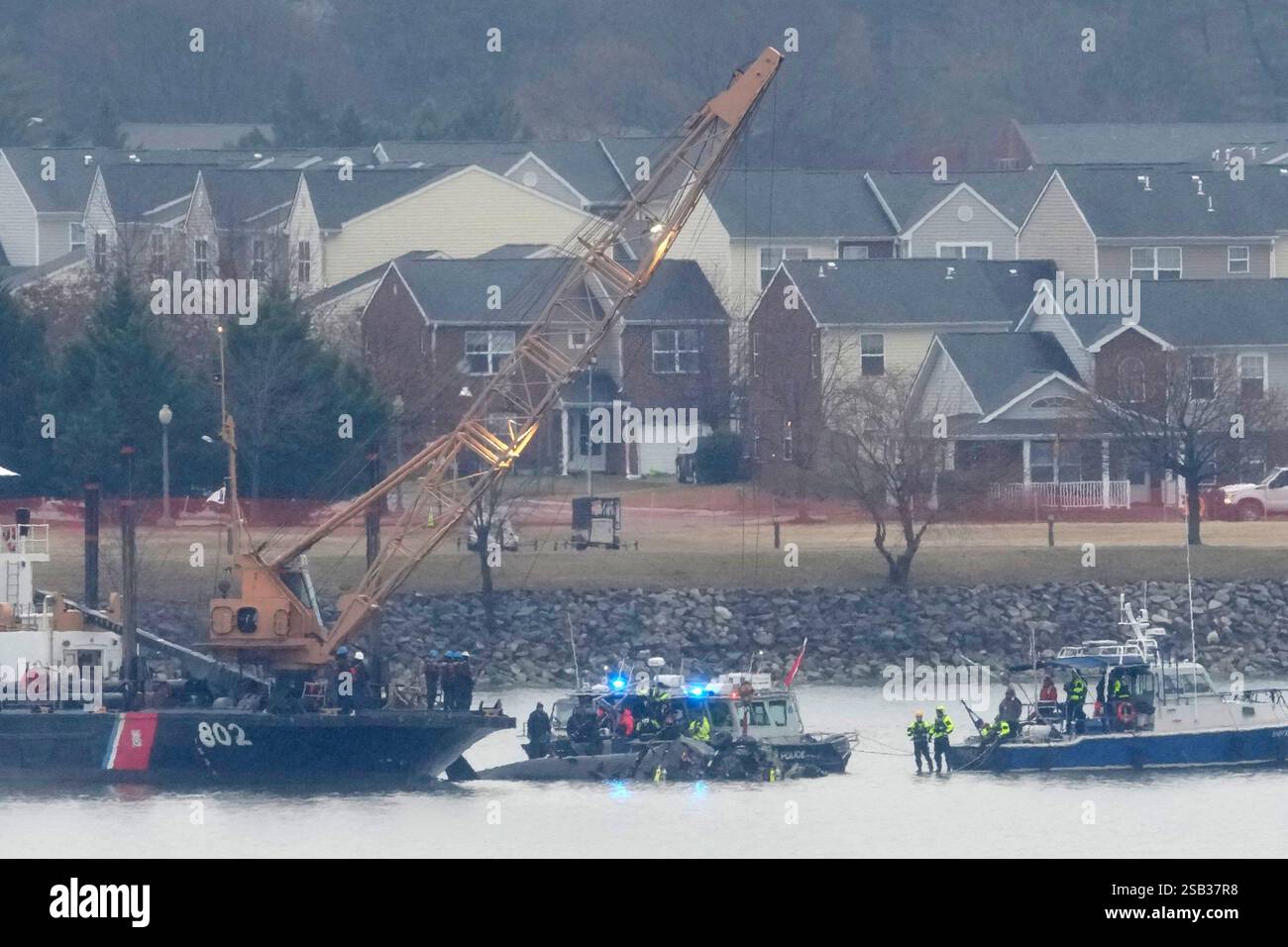 A Coast Guard vessel with a crane is pictured as it works near the ...