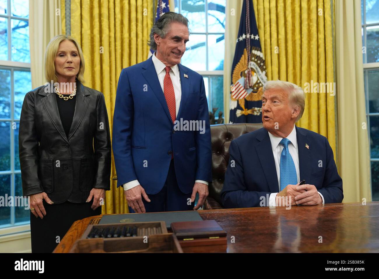 President Donald Trump talks with Interior Secretary Doug Burgum and his wife Kathryn in the ...