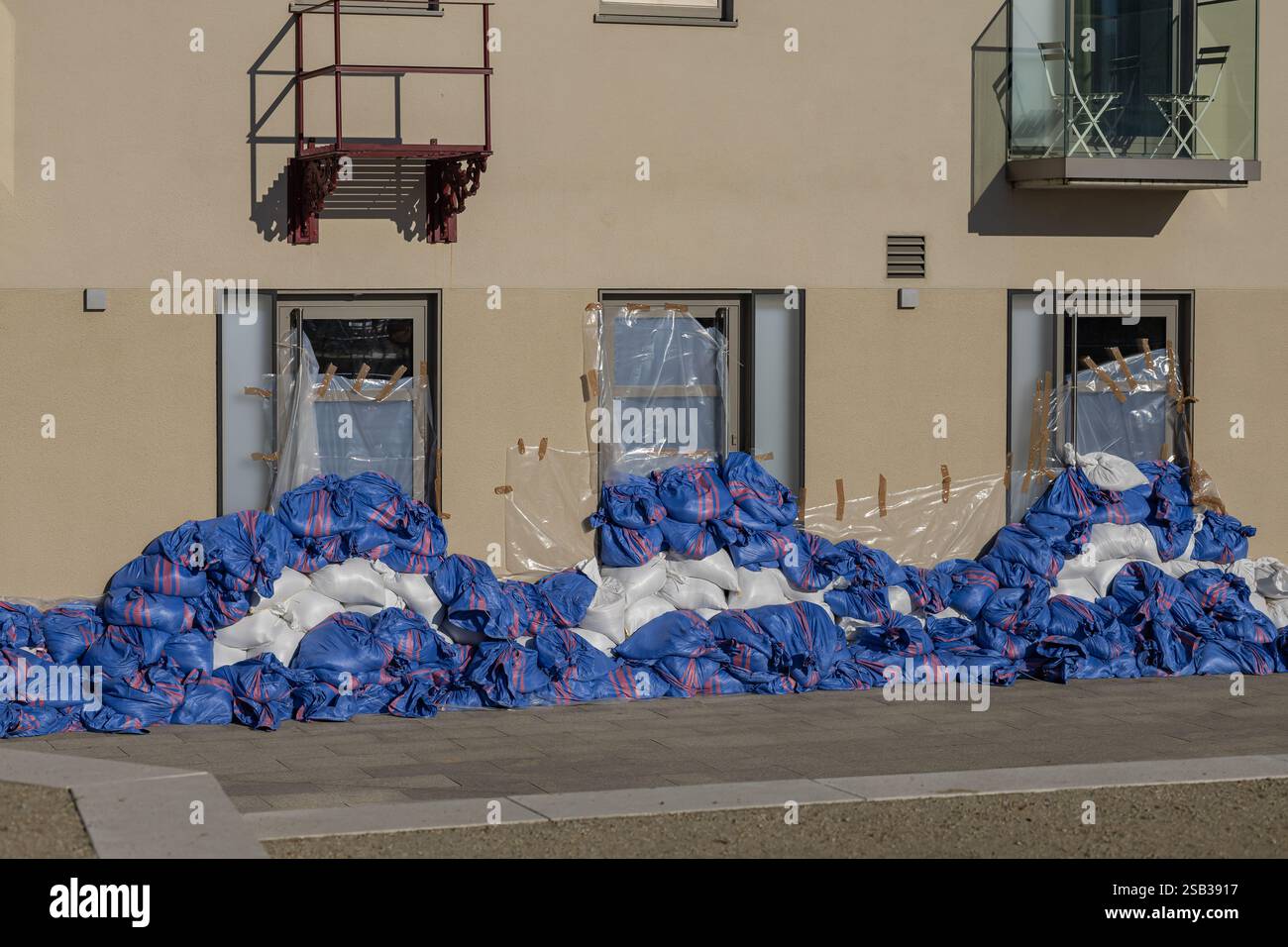 Flood protection with blue and white sandbags and plastic sheeting ...