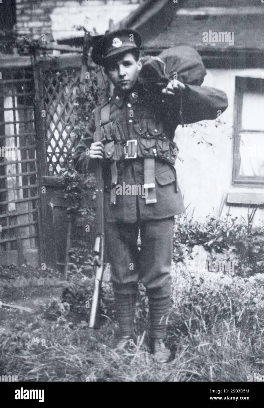 A soldier for the Middlesex Regiment with rifle and kit bag during the ...