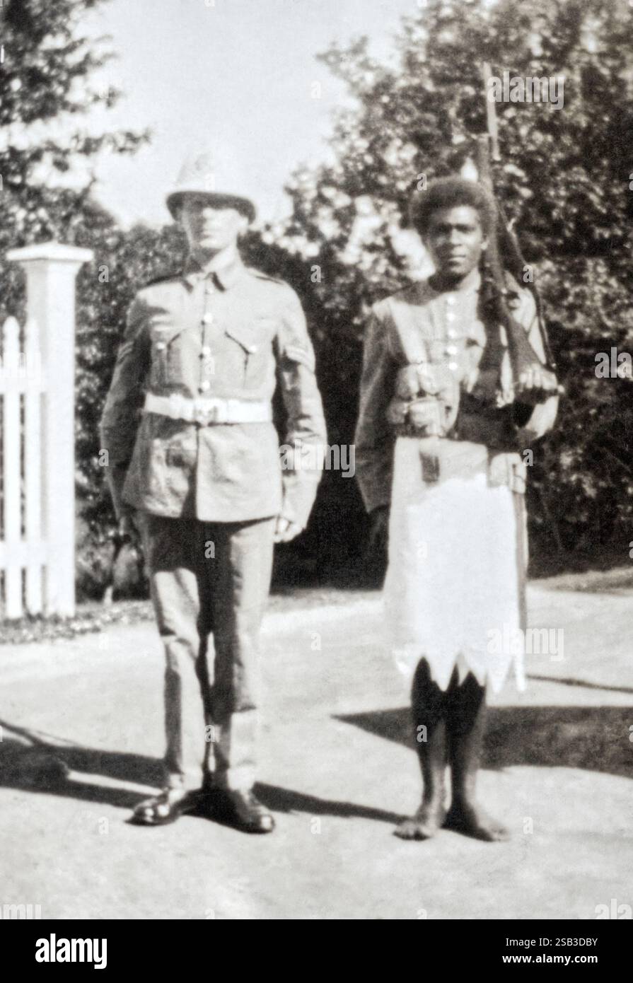 A British soldier alongside a Fijian infantryman on guard outside the ...