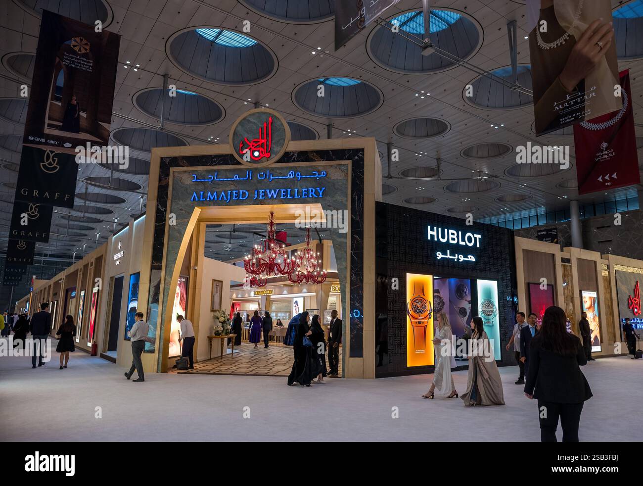 DOHA JEWELLERY AND WATCHES EXHIBITION Visitors stand next to the stand ...