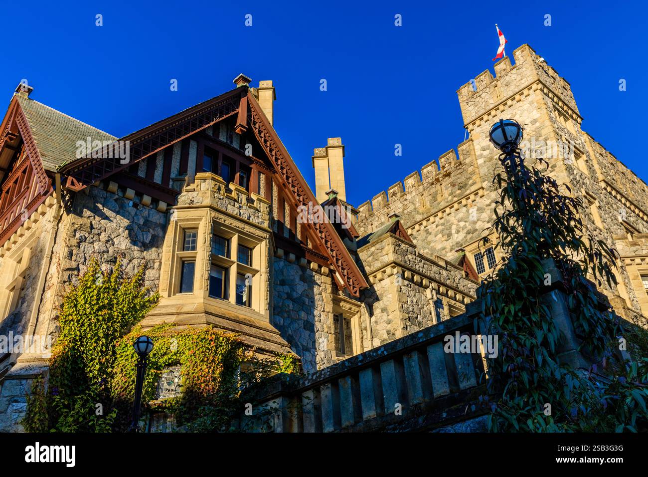 A large stone building with a clock tower. The building has a lot of ...