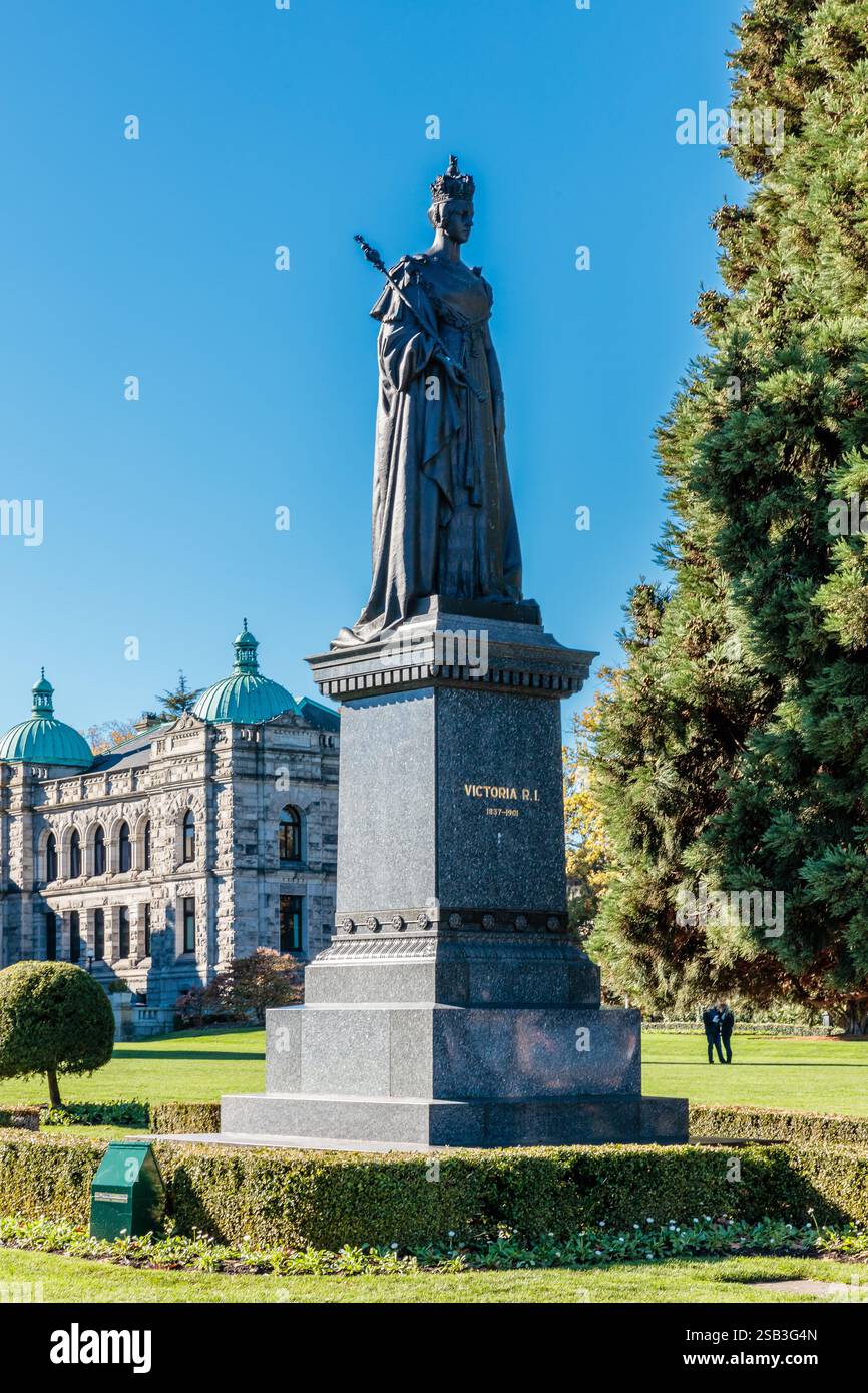 A statue of a woman with a crown on top of a pedestal. The statue is ...