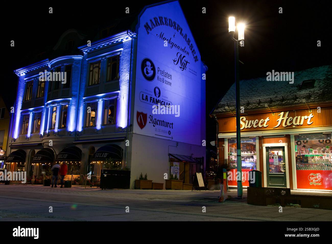 Tromso, Norway street at night: illuminated buildings, blue lights ...