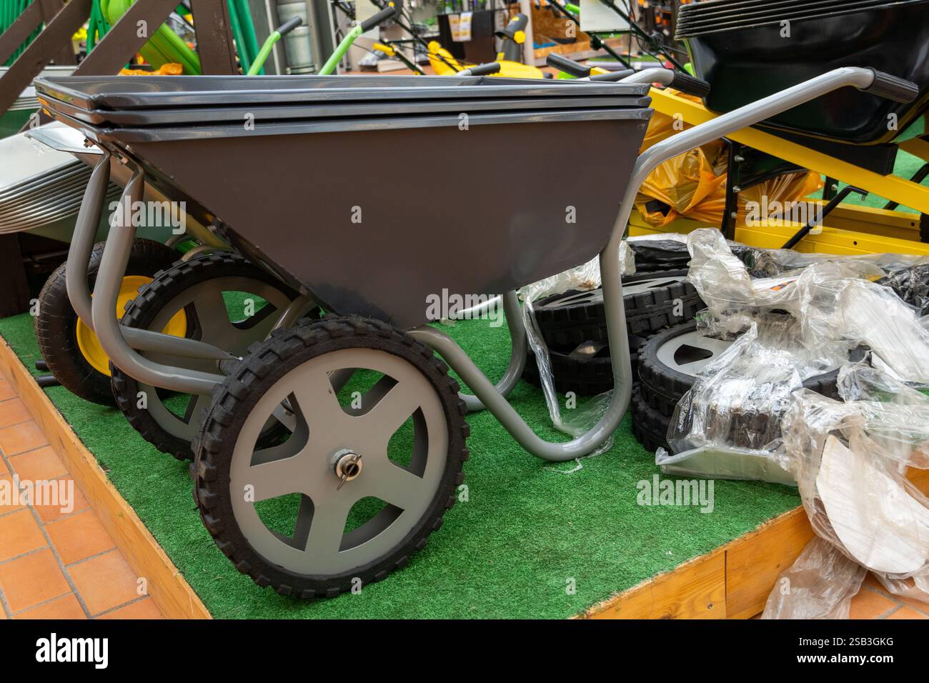 Garden wheelbarrow and tools on sale at the beginning of the garden ...