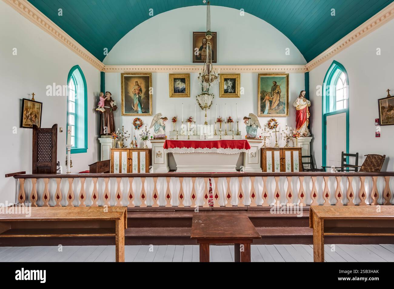 A church with a blue roof and white walls. The altar is red and there ...