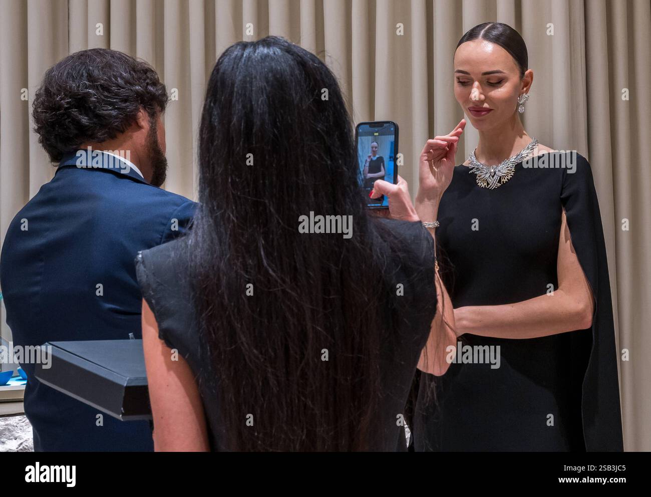 DOHA JEWELLERY AND WATCHES EXHIBITION Visitors taking photos of a model ...