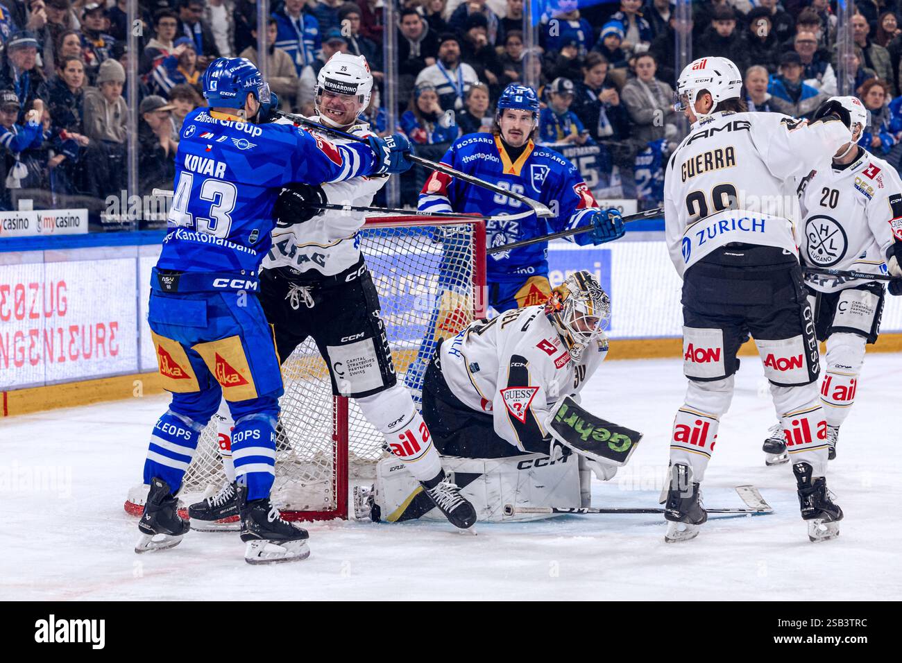 Jan Kovar #43 (EV Zug) crosschecks Mirco Muller #25 (HC Lugano) in the ...
