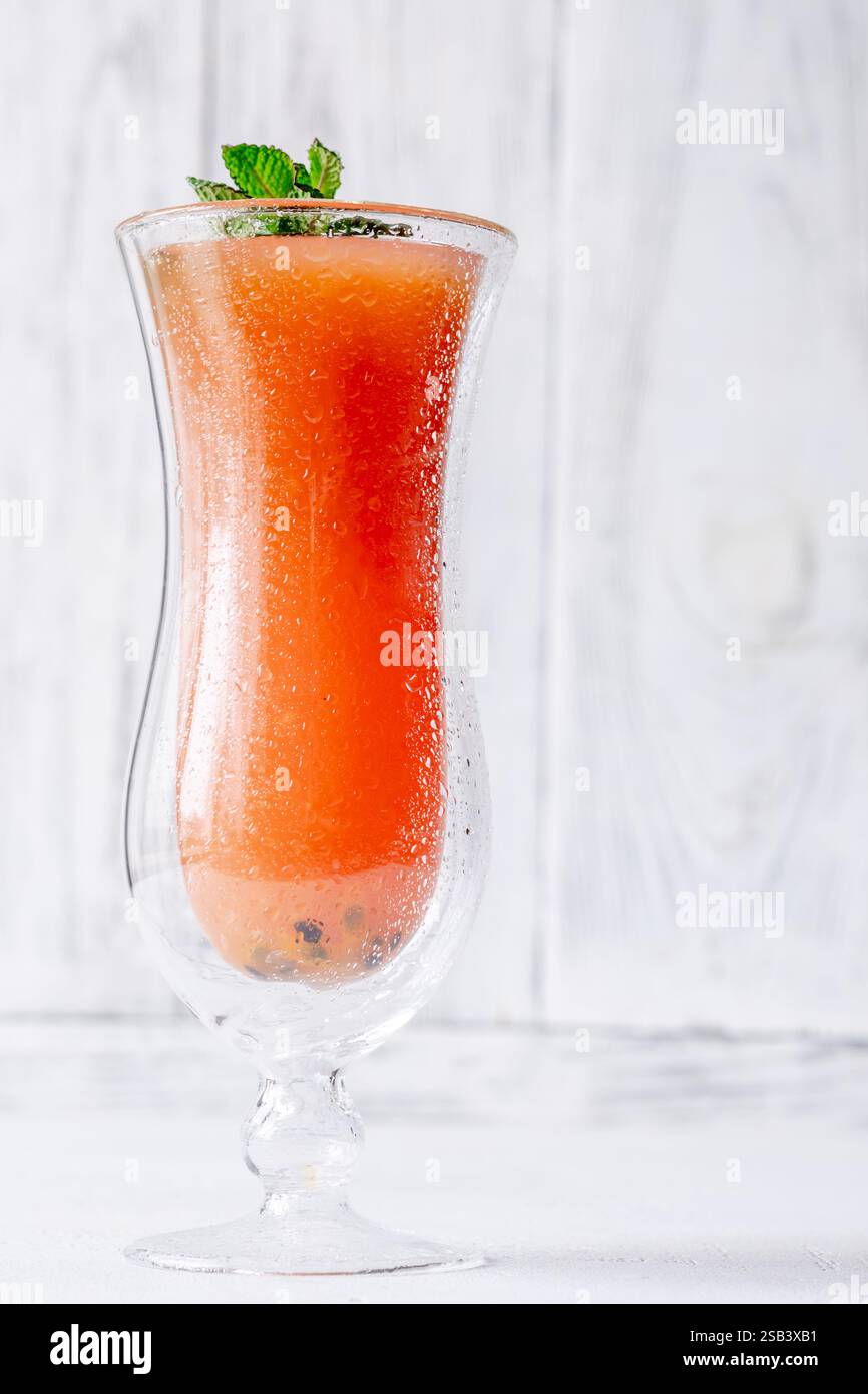 Vibrant Jamaican Me Crazy cocktail in hurricane glass, mint garnish for refreshing twist Stock ...