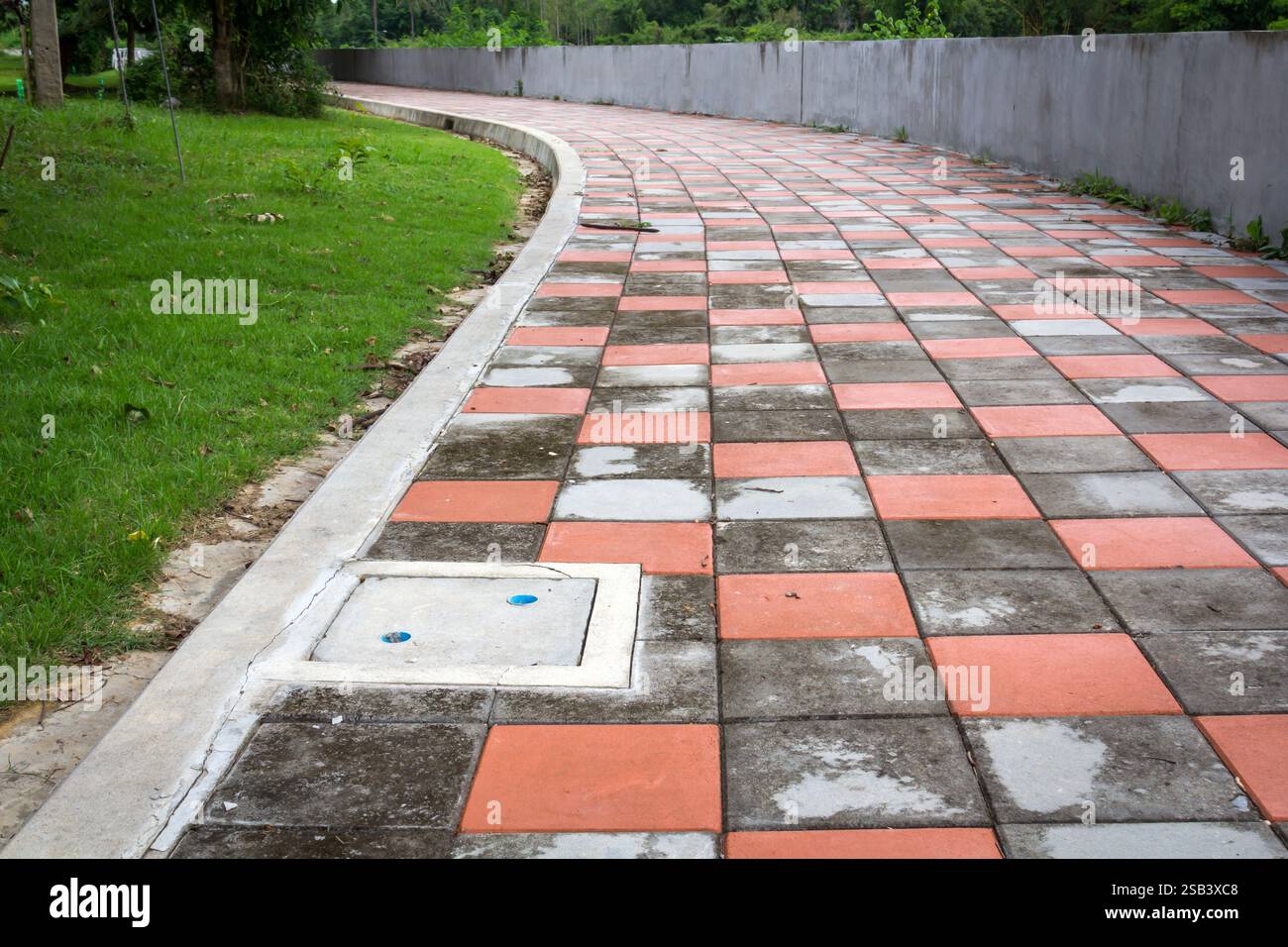 The Stone block walk path in the park with green grass background Stock ...