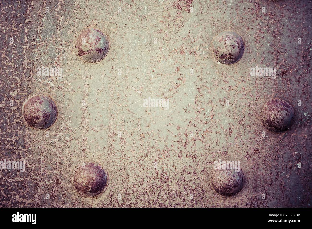 A metal surface with a hole in the center and four holes surrounding it ...