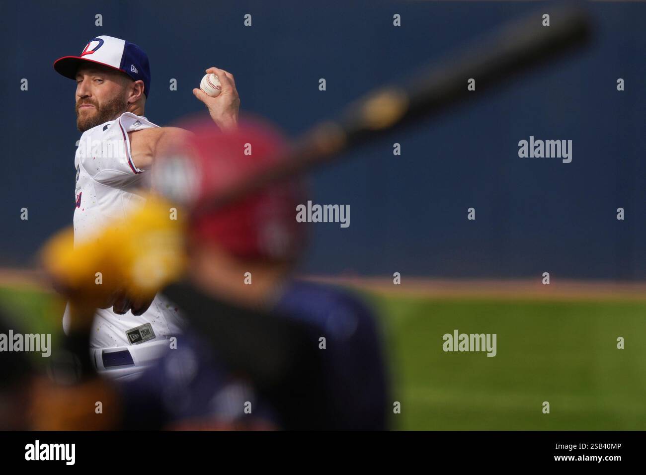 Dominican Republic's starting pitcher Brooks Hall, top, throws against ...