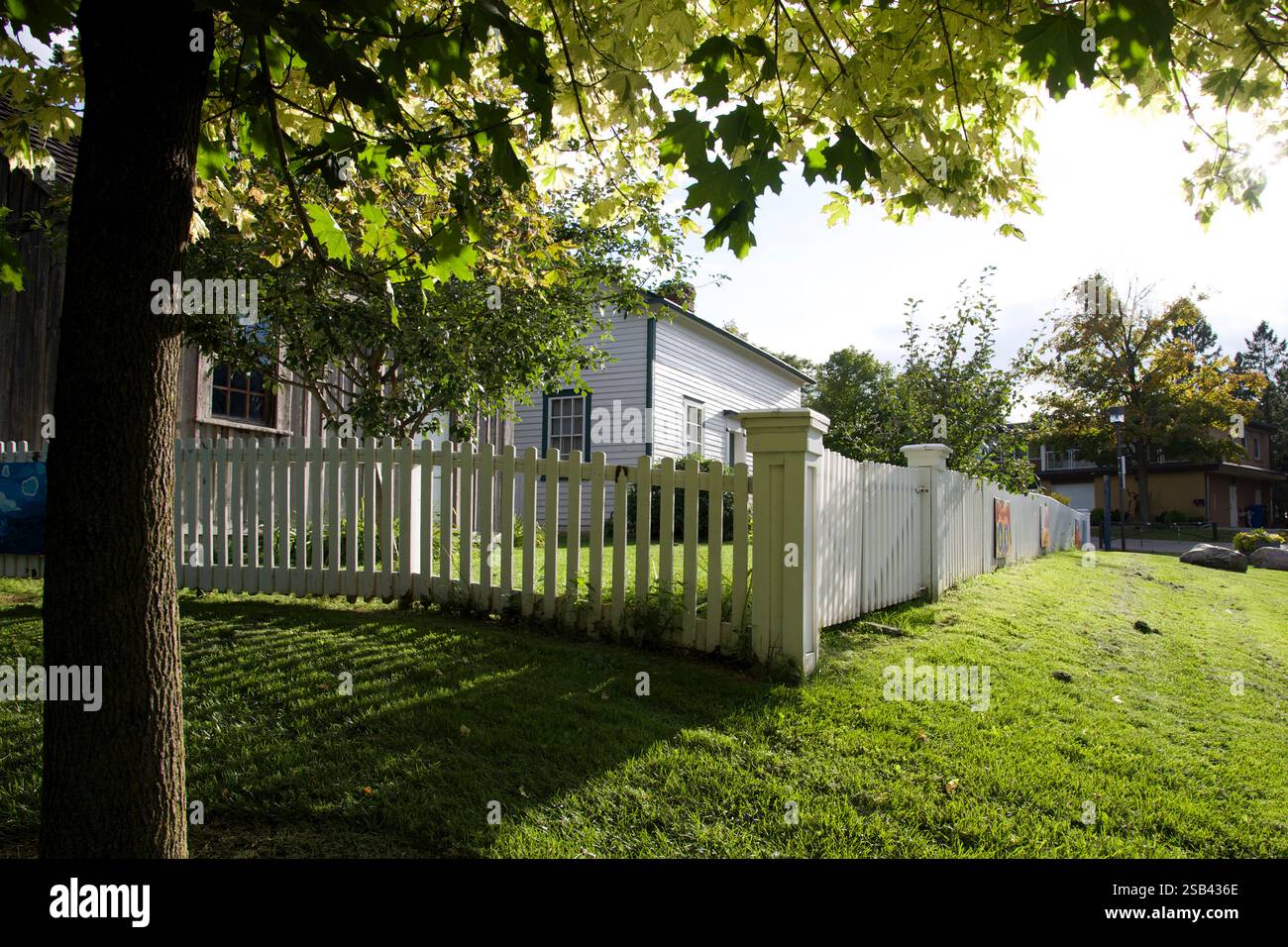 House exterior with a white picket fence in springtime Stock Photo - Alamy