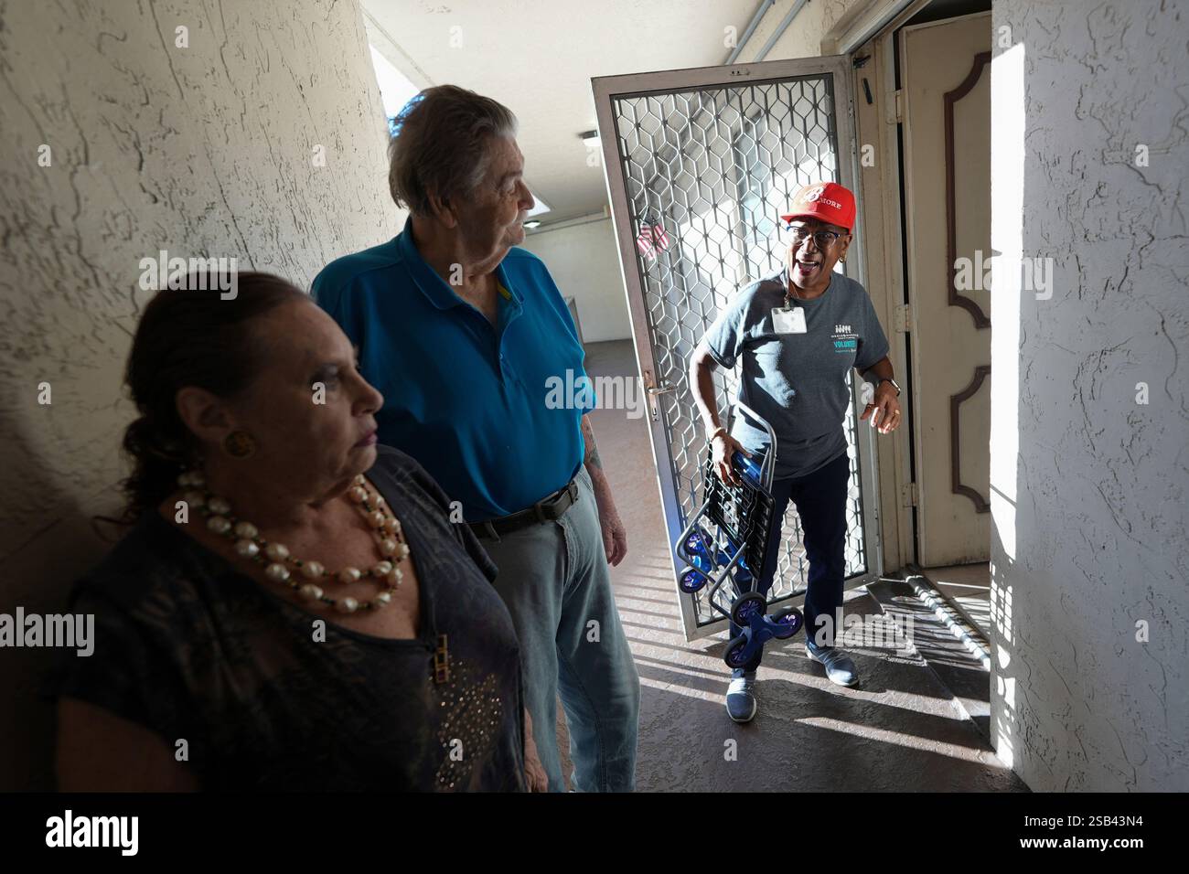 Volunteer Sheilia "Toni" Thornton, right, delivers food to Phyllis ...