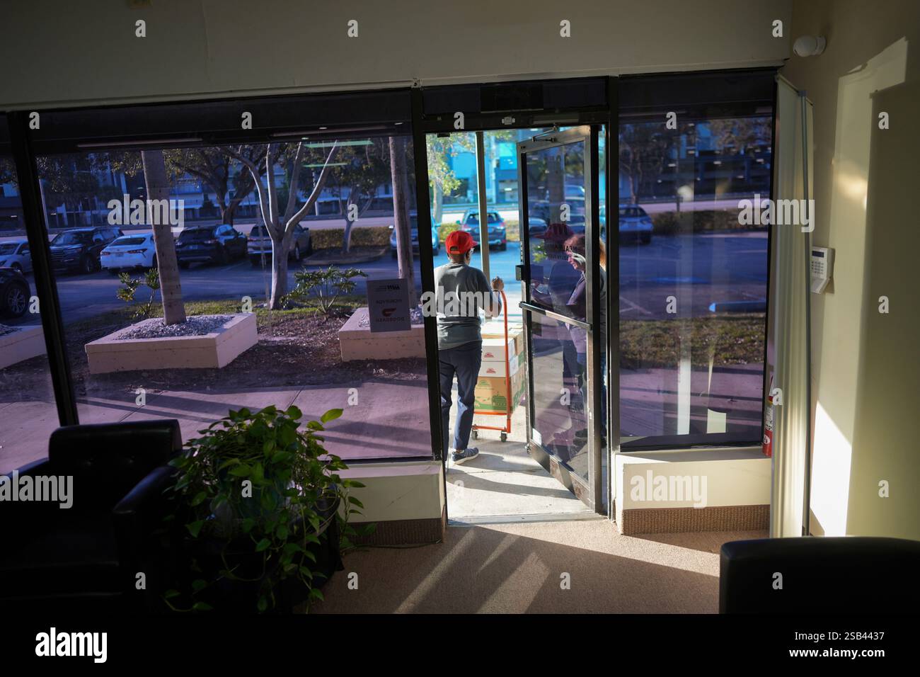 Volunteer Sheilia "Toni" Thornton pushes a cart with boxes of food as ...
