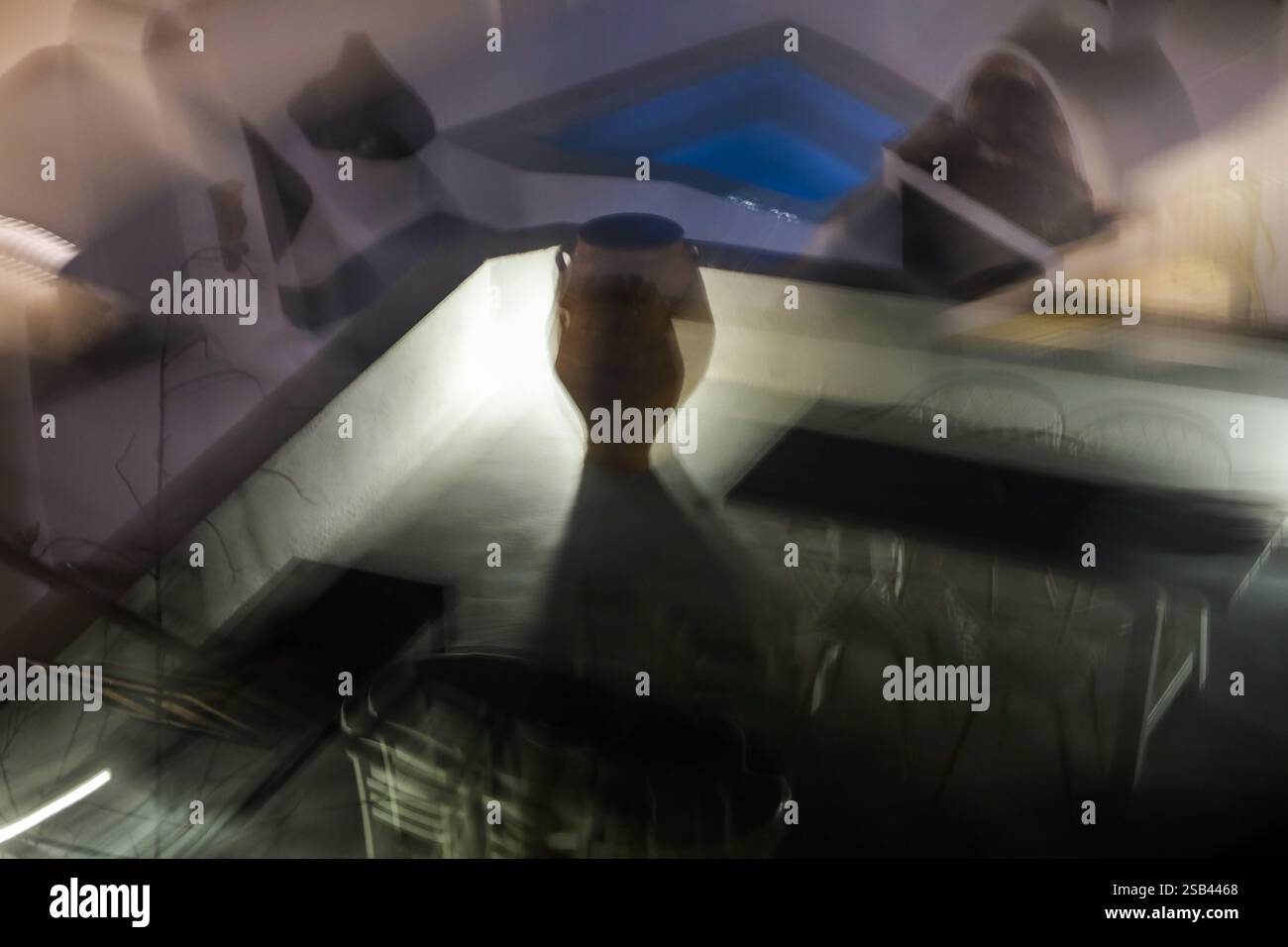 A surreal, nighttime scene featuring an outdoor patio with a large ...