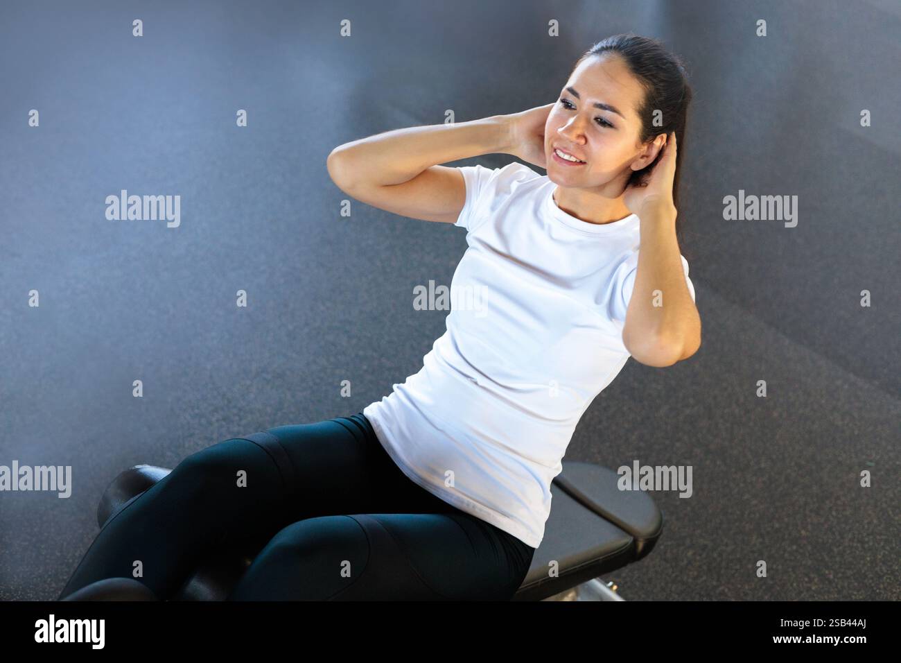 Young beautiful Asian woman with athletic build and good figure doing ...