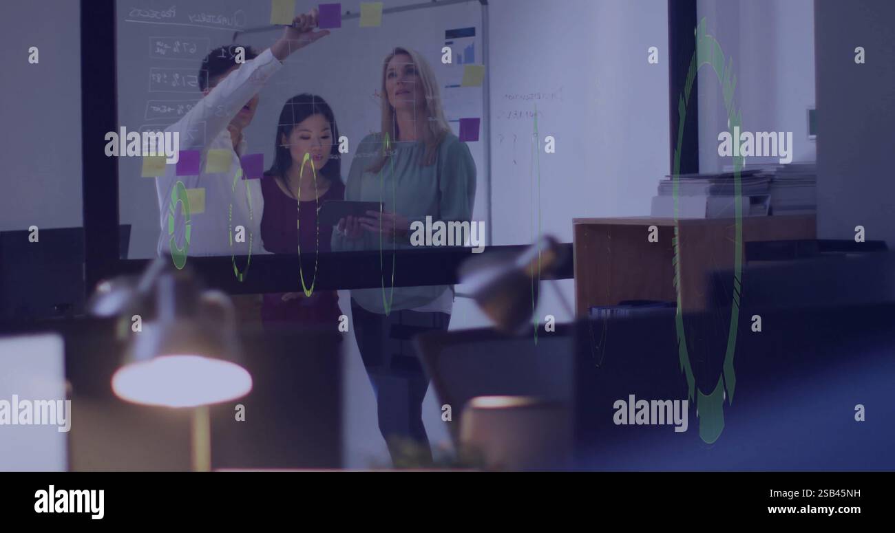 Team collaborating on project with data visualization image over office ...