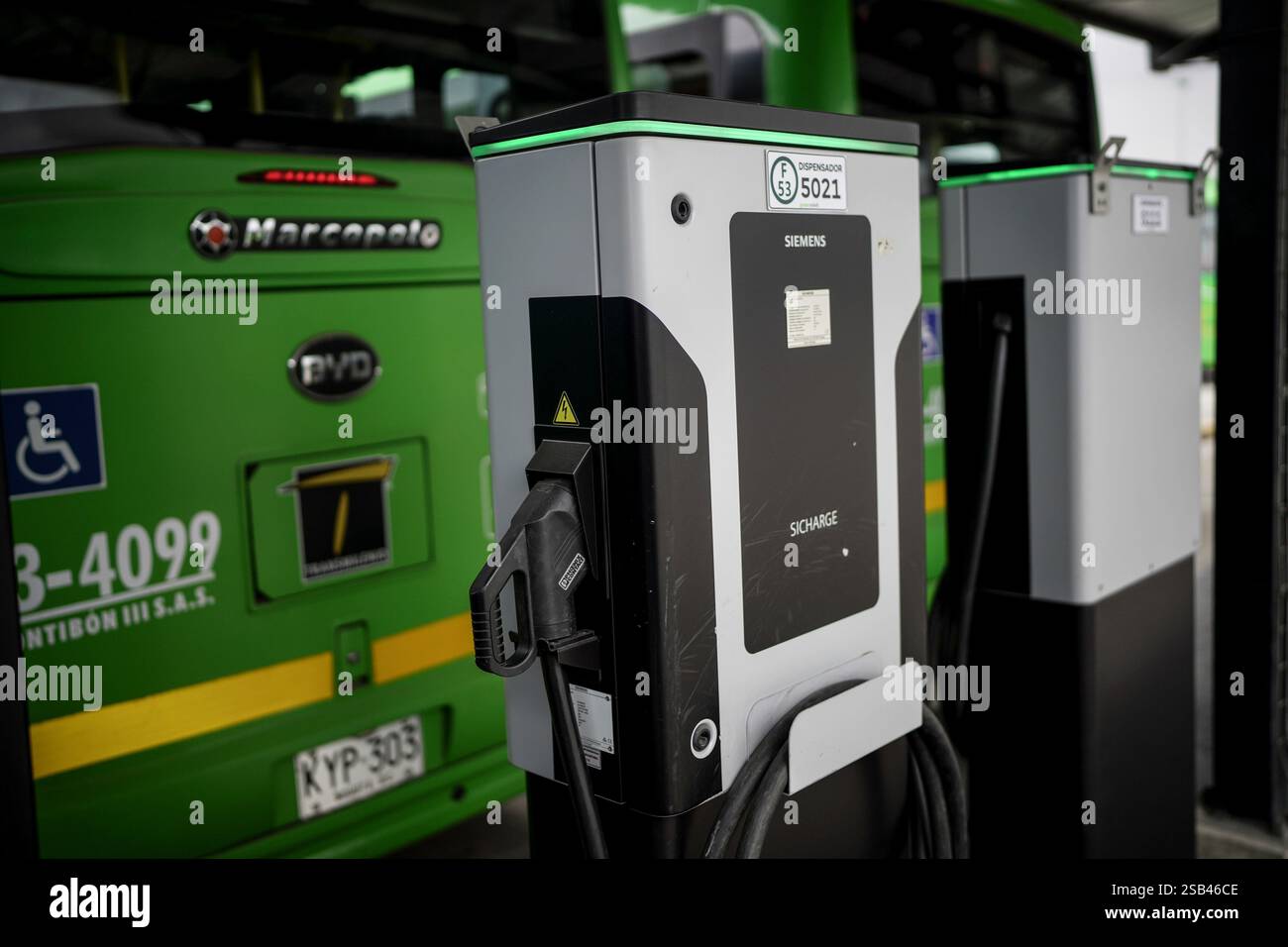 Electric buses, of the company, TransMilenio, sit at the station to ...